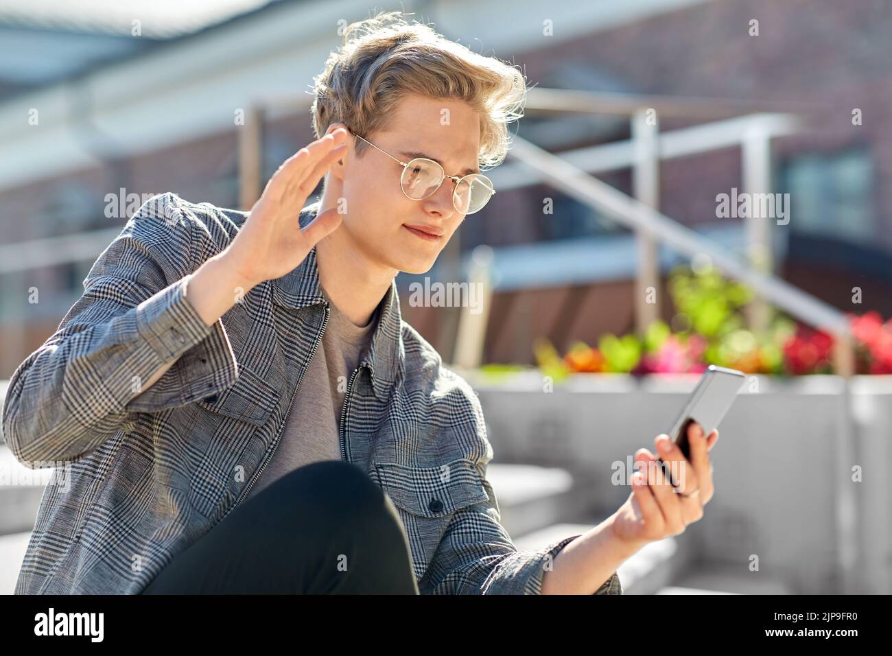 teenage boy with smartphone having video call Stock Photo - Alamy