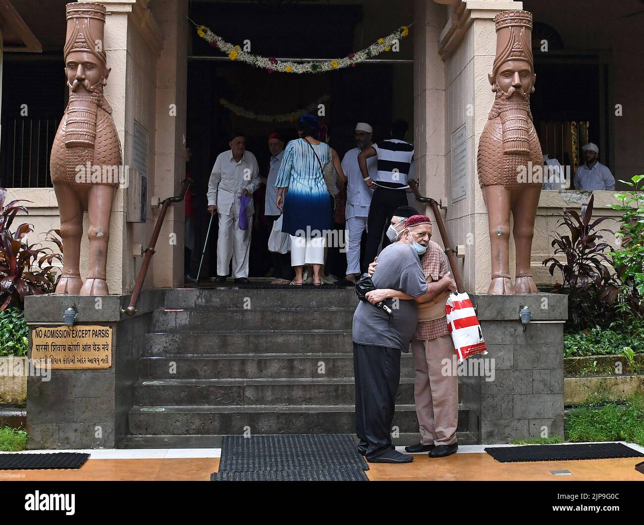 Mumbai, India. 16th Aug, 2022. Parsi men seen hugging each other at the ...