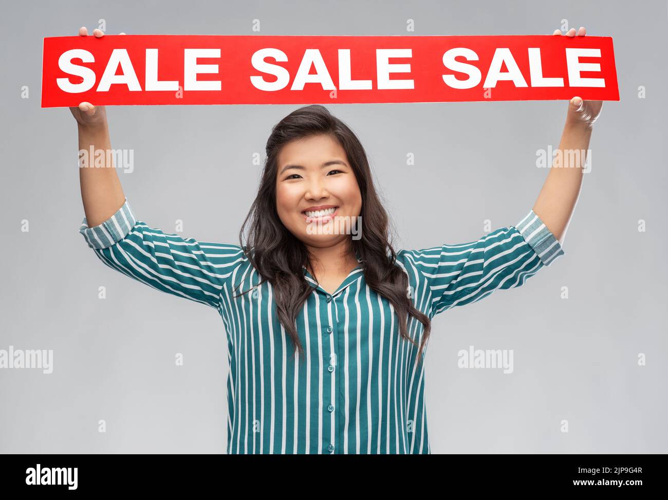 happy smiling young asian woman with sale banner Stock Photo - Alamy