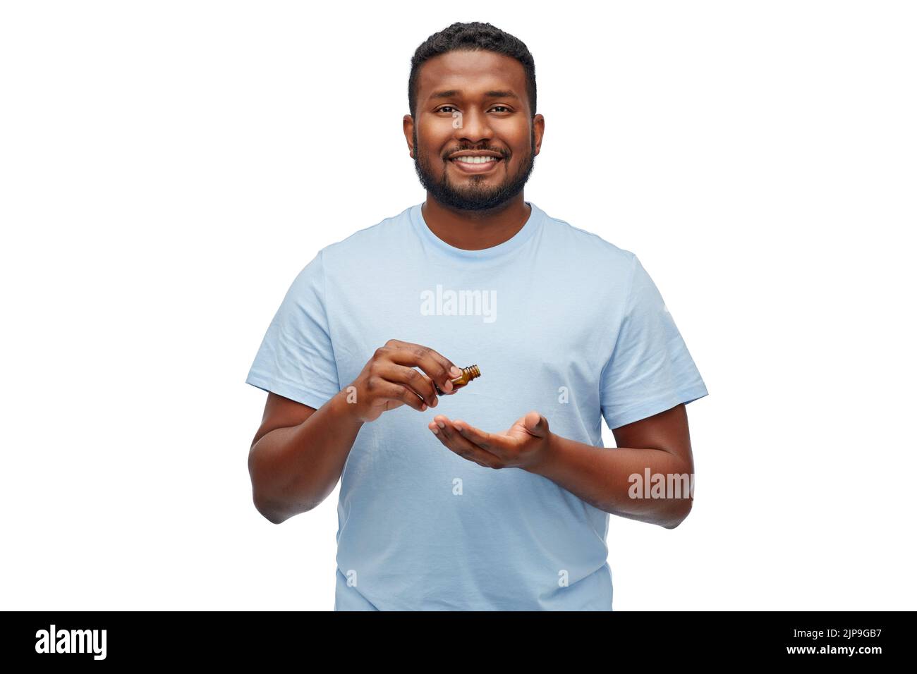 african man applying grooming oil to beard Stock Photo - Alamy