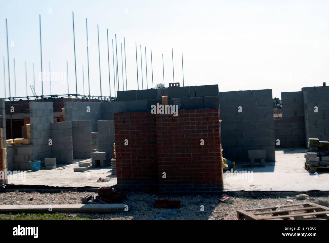 Partially constructed house surrounded by scaffolding on building site ...