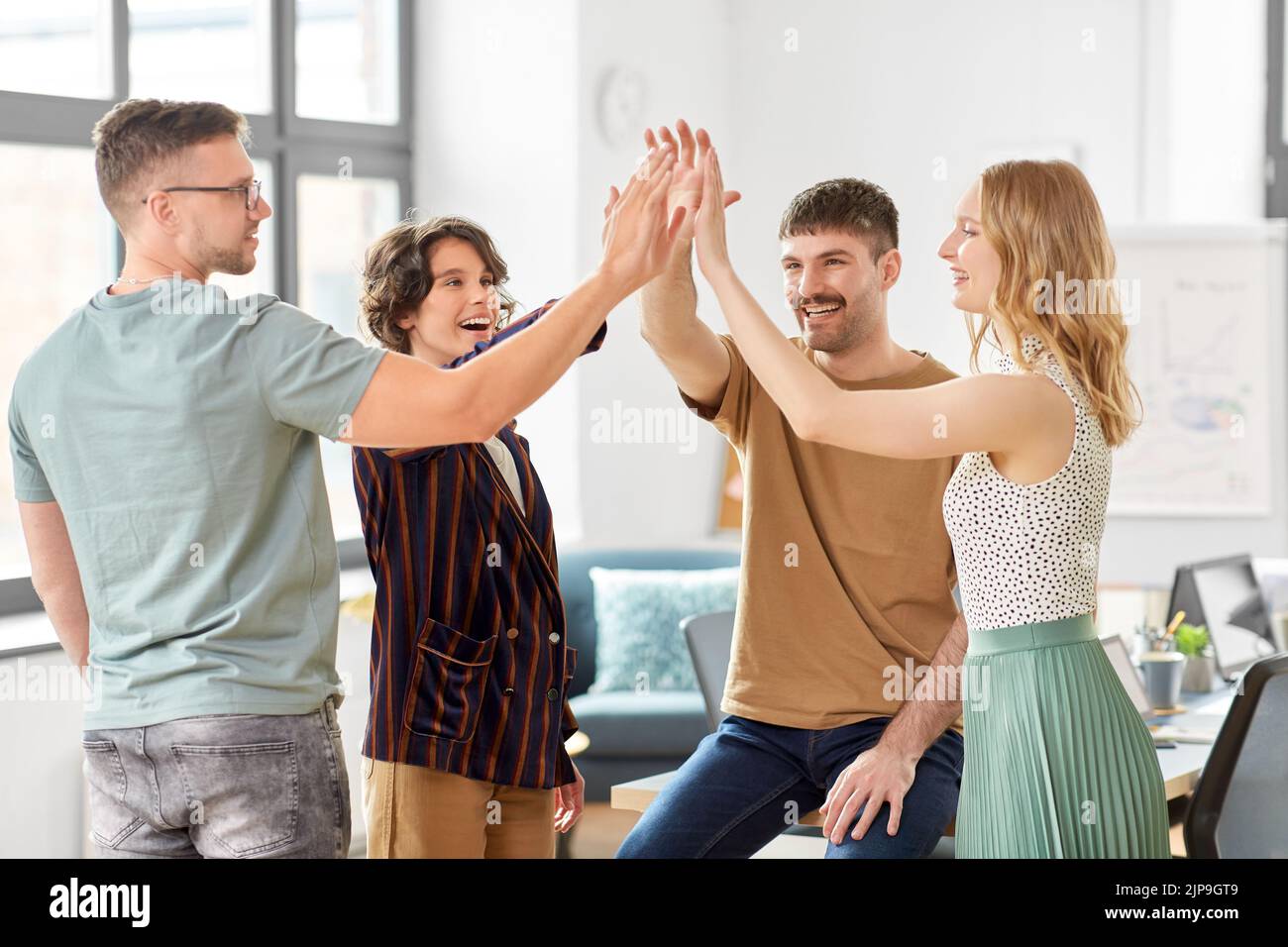 happy business team making high five at office Stock Photo - Alamy