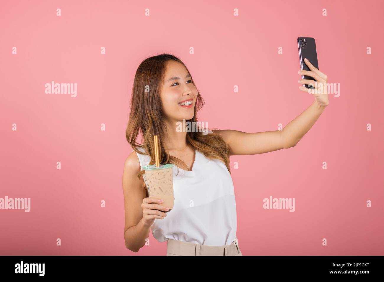Asian woman takes photo of herself with drinking brown sugar flavored ...