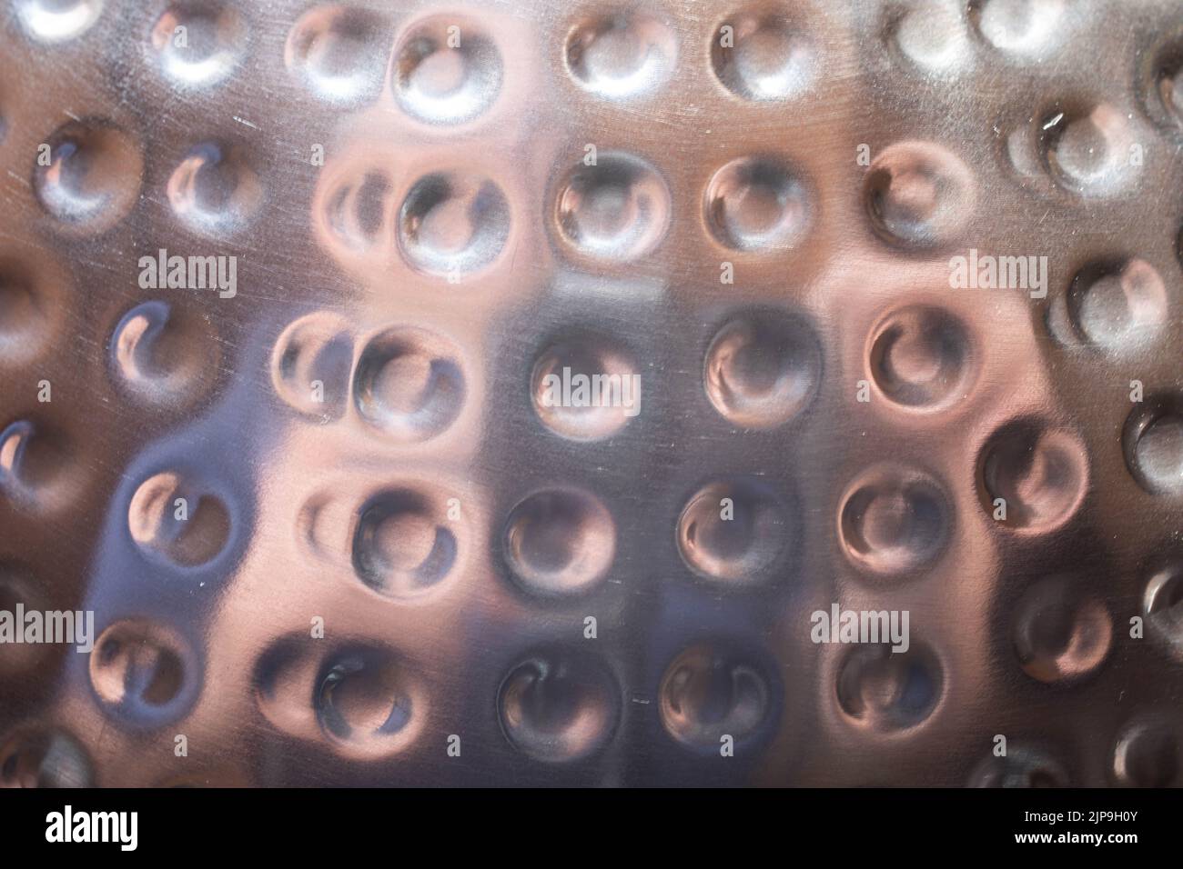 Metal surface with round dents in the surface Stock Photo - Alamy