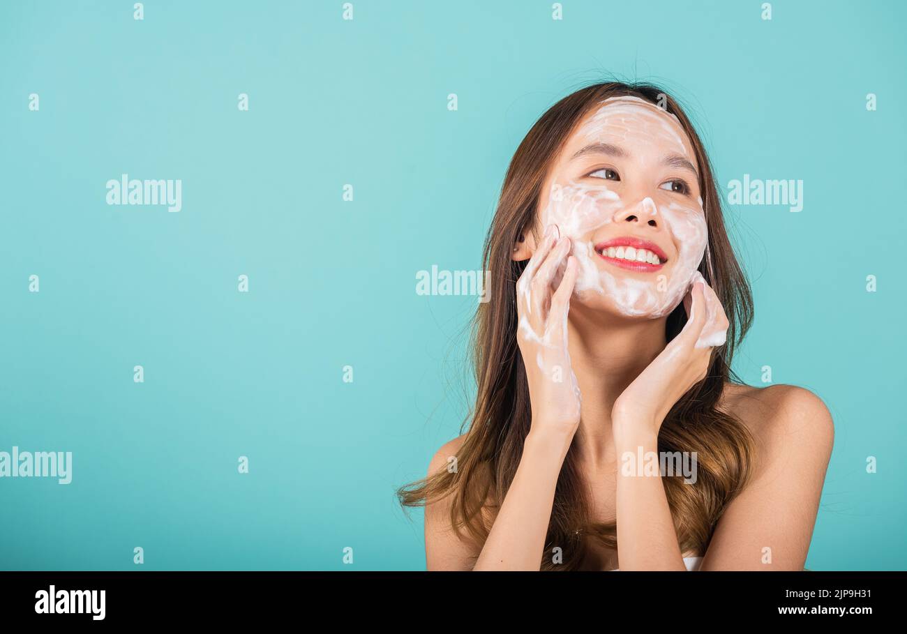 Portrait beautiful female smile applies foaming cleanser healthy skin ...