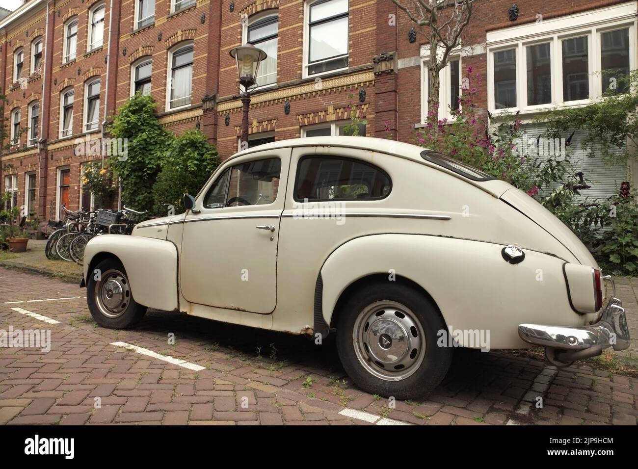 Old Volvo PV544 parked in front of housing in Amsterdam, Netherlands ...