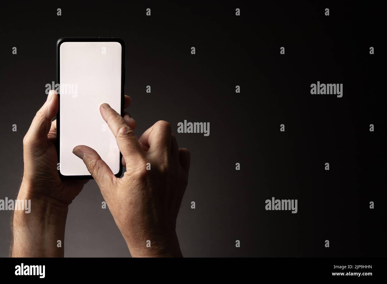 Man's hands holding smart phone and pinch zooming with blank white ...