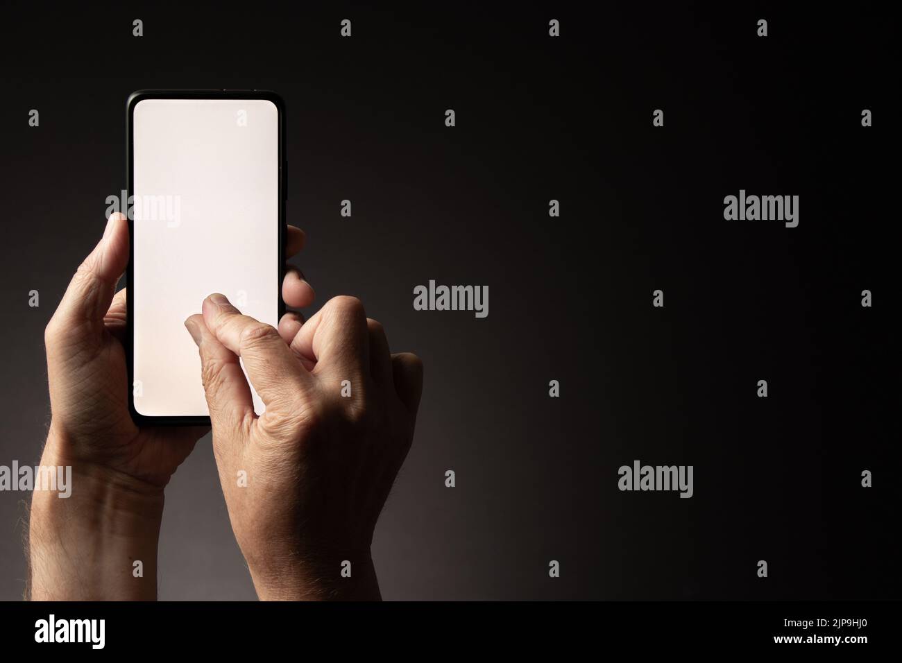 Man's hands holding smart phone and pinch zooming with blank white ...