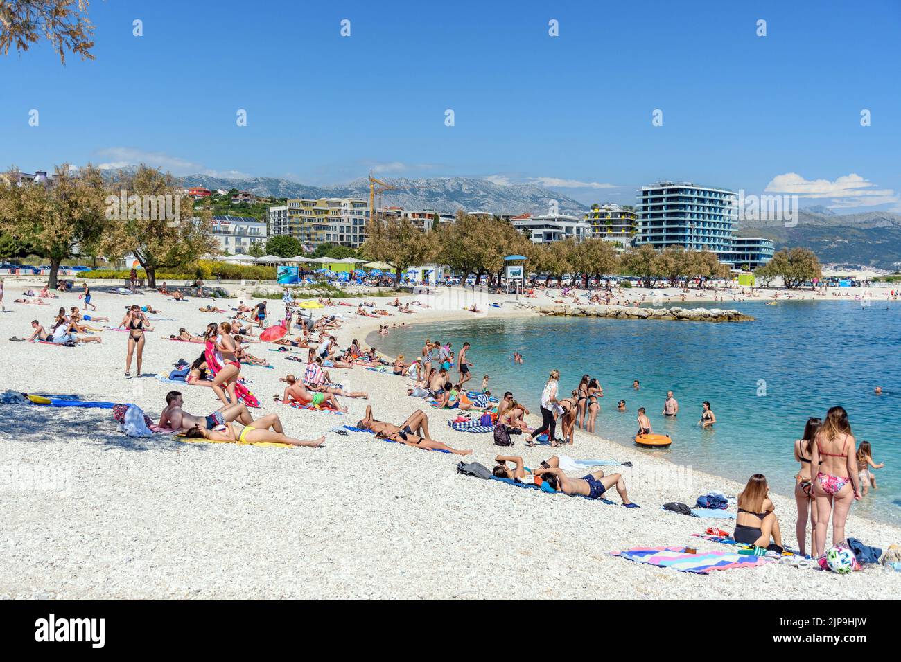 People resting on Znjan city beach on a sunny summer day in Split ...