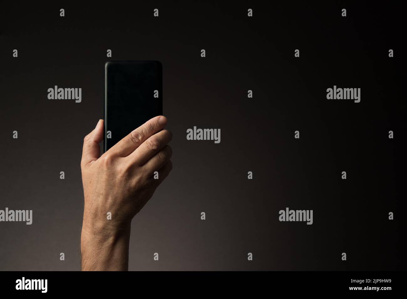 Rear view hand holding smart hi-res stock photography and images - Alamy