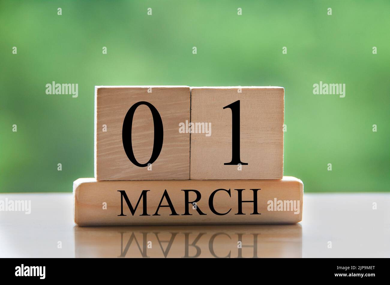 March 1 calendar date text on wooden blocks with blurred park ...