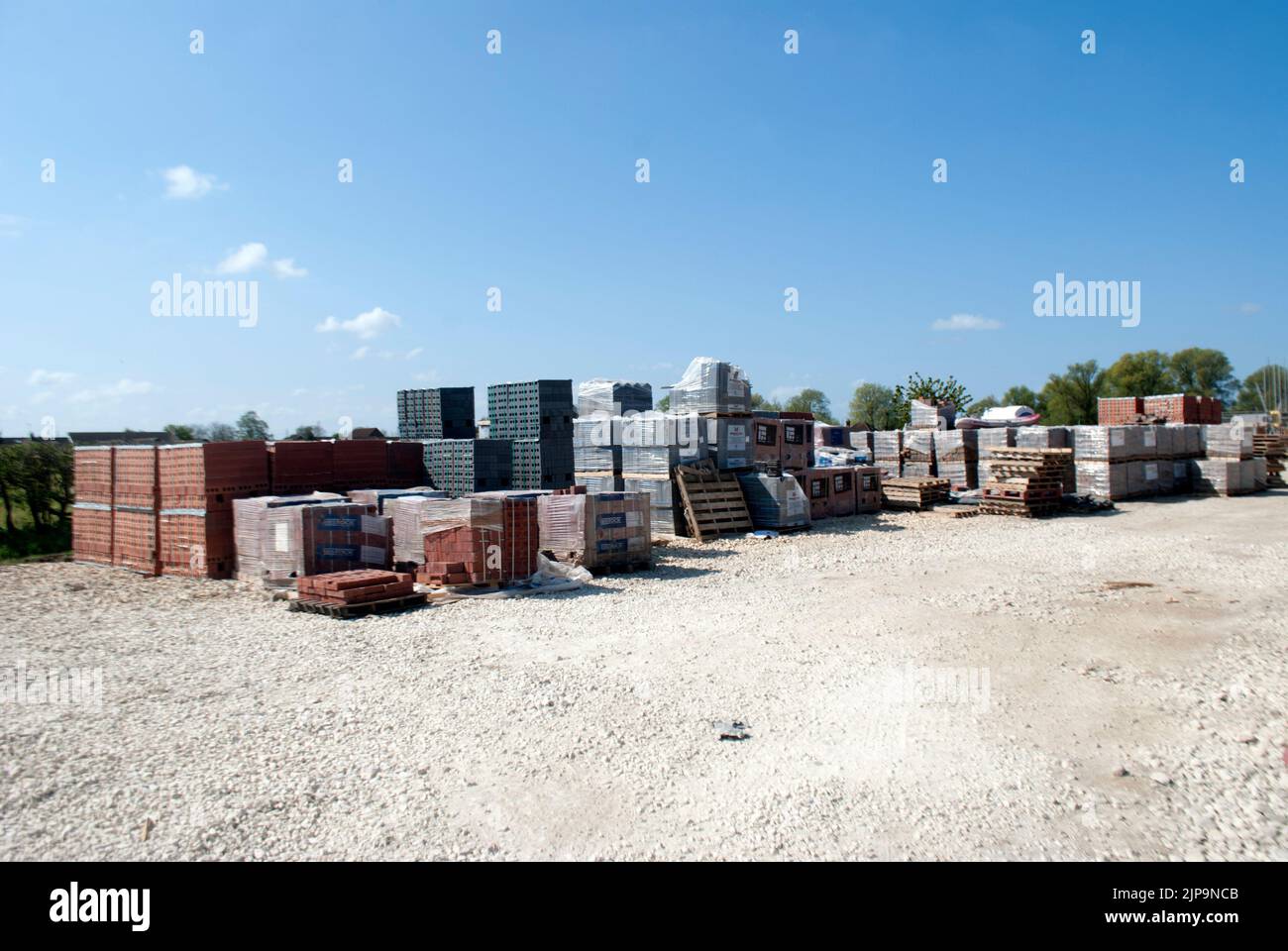Stacked pallets of building materials on a building site Stock Photo ...