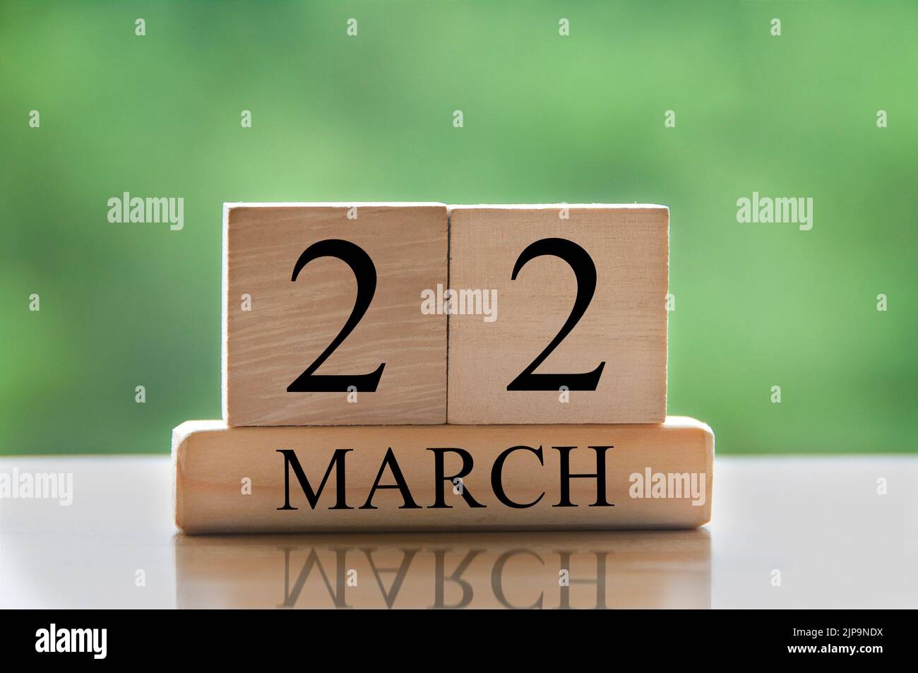 March 22 calendar date text on wooden blocks with blurred park ...