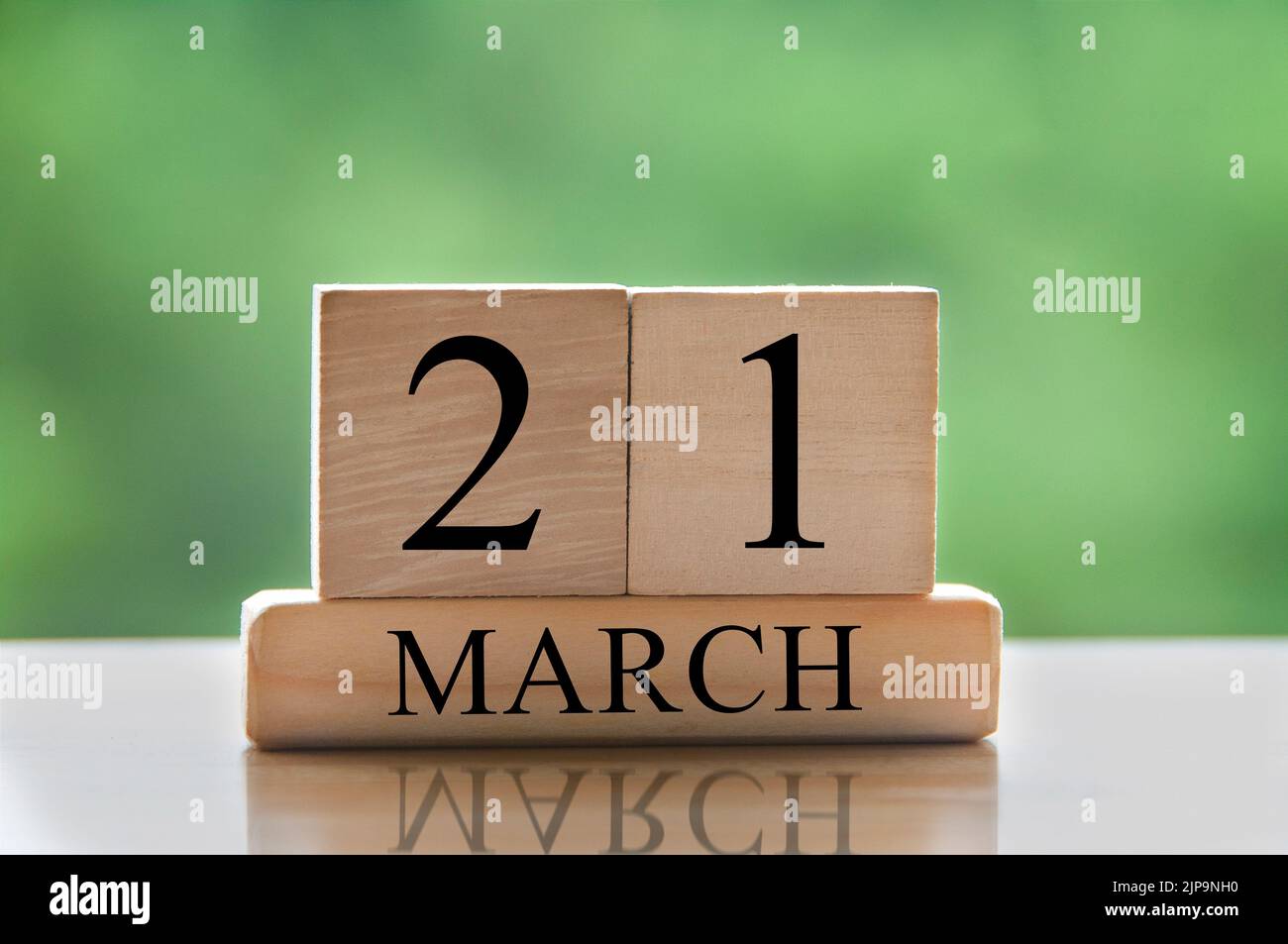 March 21 calendar date text on wooden blocks with blurred park ...