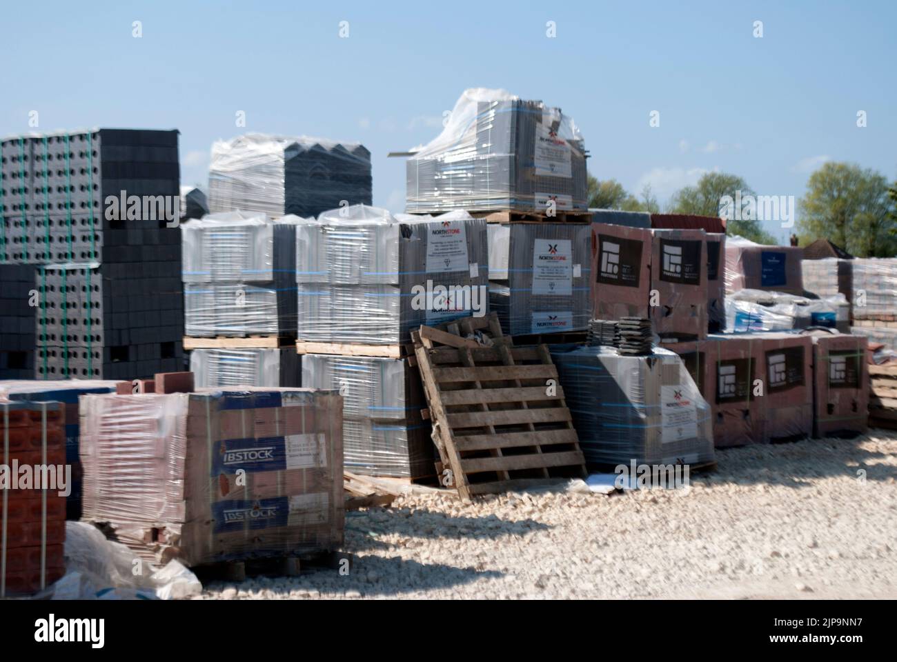 Stacked pallets of building materials on a building site Stock Photo ...