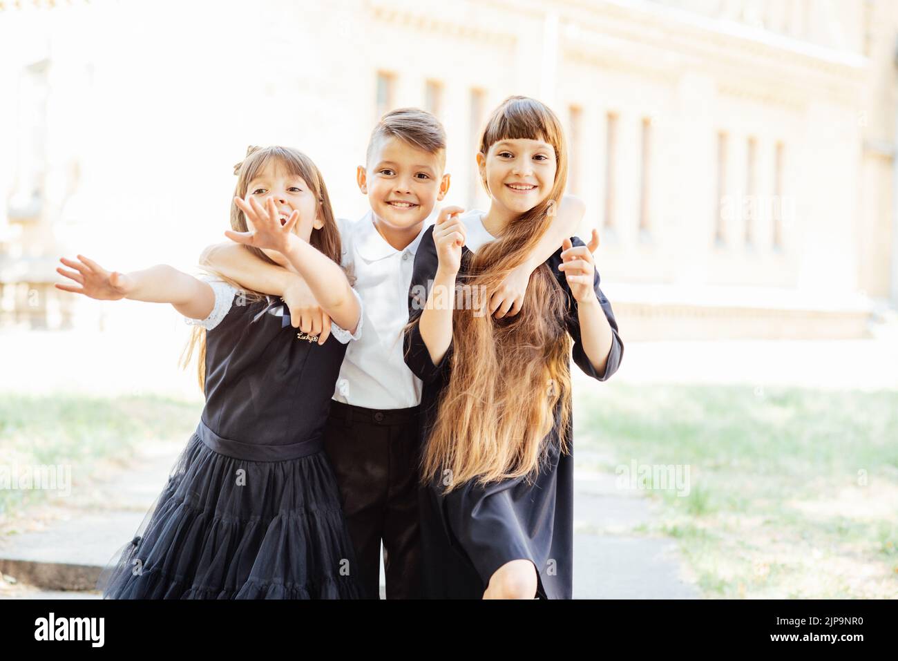 Portrait Of Excited Elementary School Pupils On Playing Field At Break ...