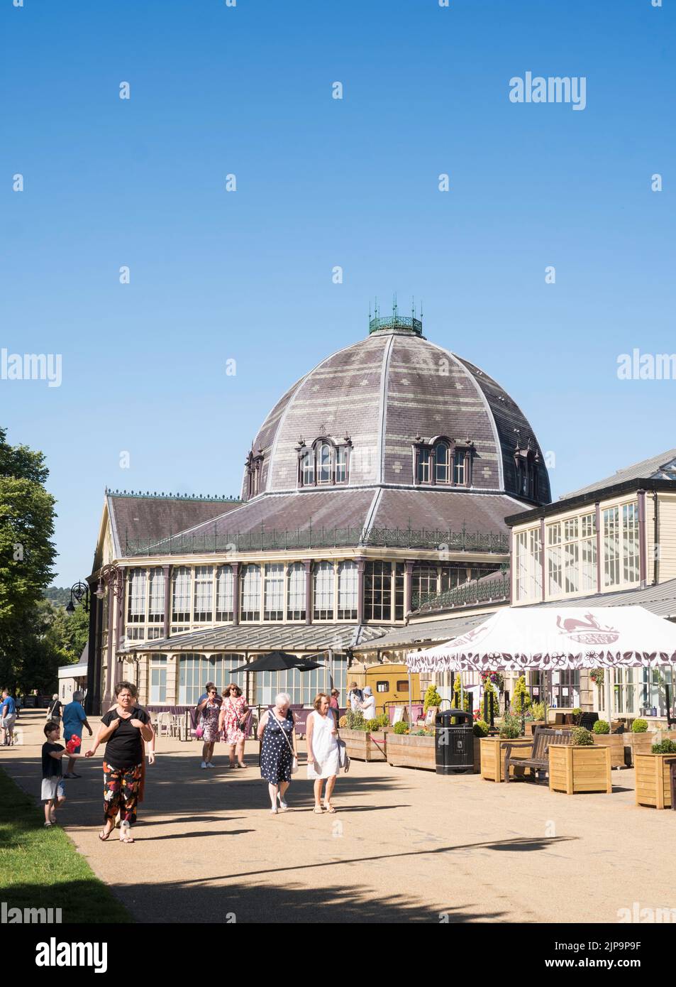 People walking through Buxton Pavilion gardens past the Octagon Concert ...