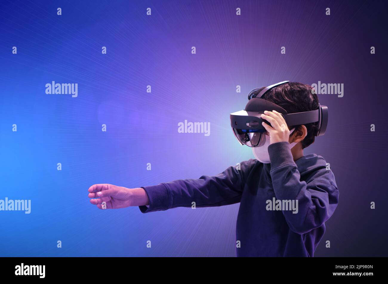 Asian kid boy using metaverse VR virtual reality glasses to digital ...