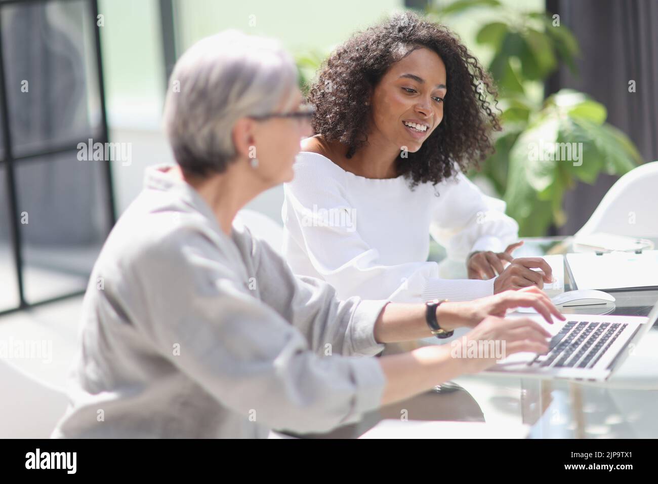 Software development team discussing algorithms on computer screen in ...