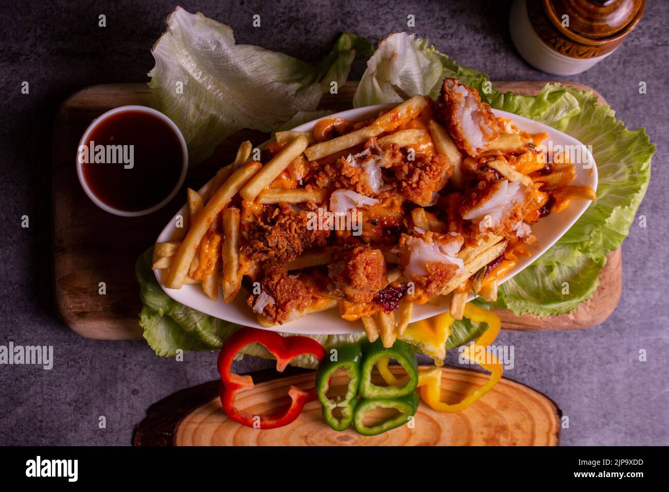 Dish of cheesy fish popcorn fries at cafe restaurant. American fast ...