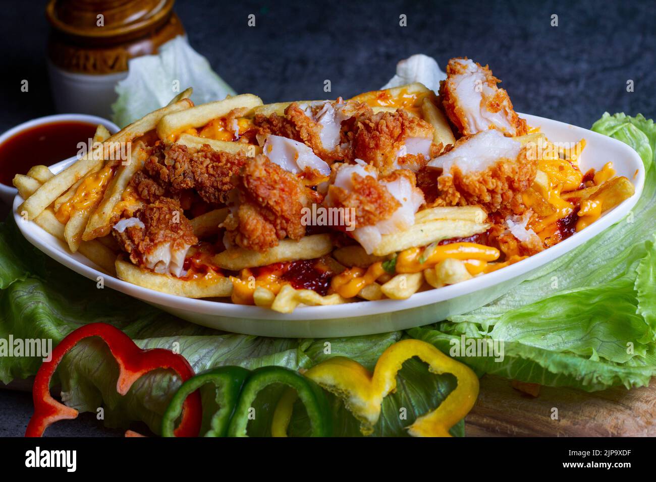 Dish of cheesy fish popcorn fries at cafe restaurant. American fast ...