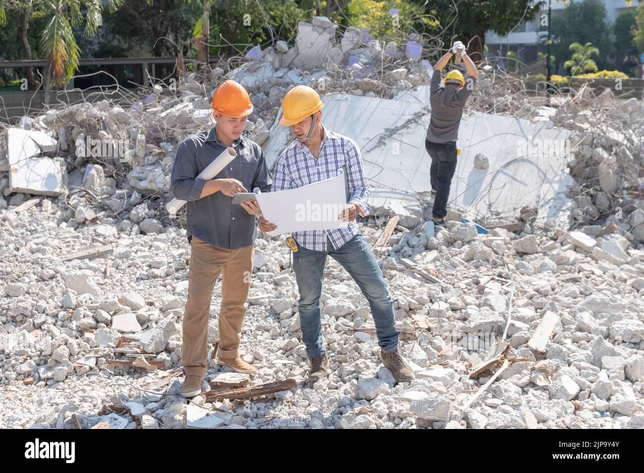 Engineer architect and worker operation control demolish old building ...