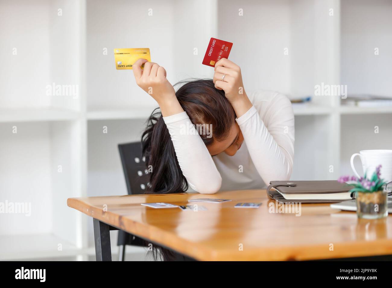 Asian woman holding credit cards Feeling stress, worry about the ...