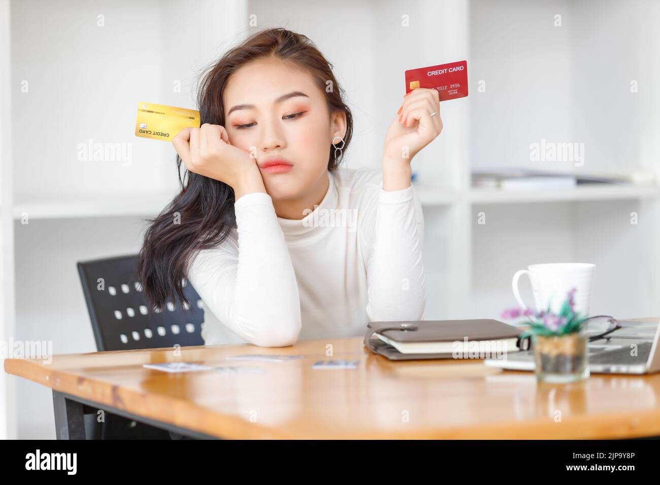 Asian woman holding credit cards Feeling stress, worry about the ...