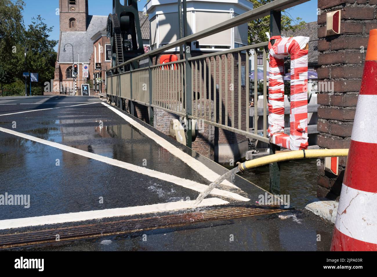 Cold water from hose cools the movable parts of a drawbridge to prevent ...
