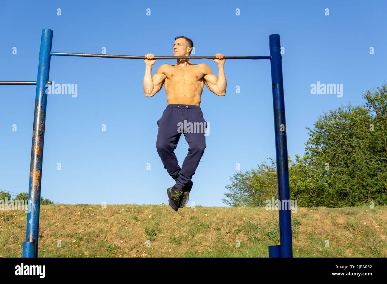 Strong man workout pull ups outdoor Stock Photo - Alamy