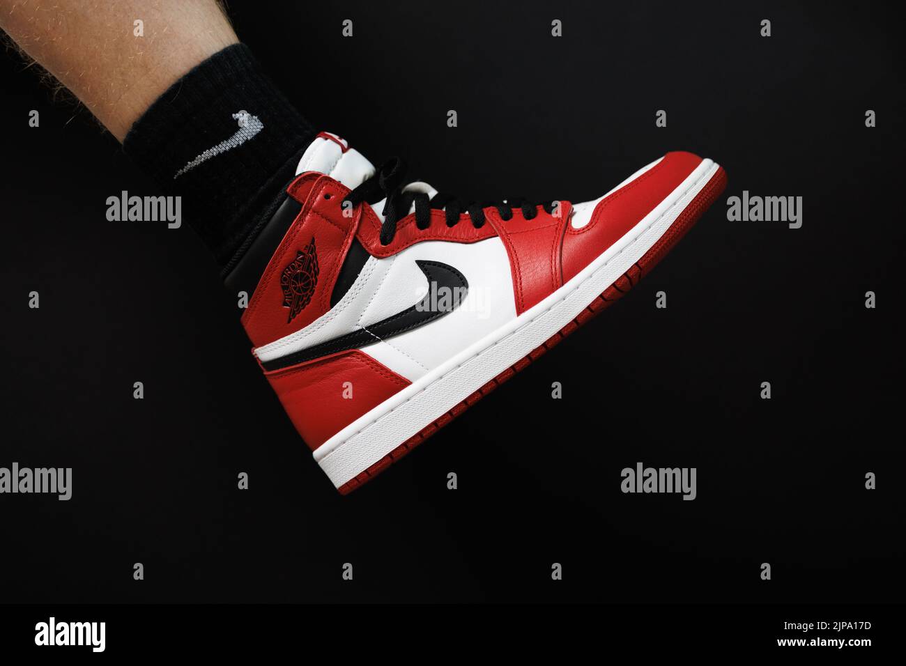 An Air Jordan 1 Chicago Colorway isolated on a black background Stock ...