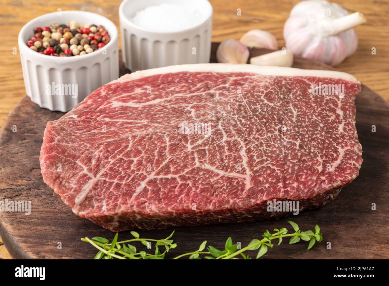 Raw wagyu shoulder roast meat over wooden board with seasonings Stock ...
