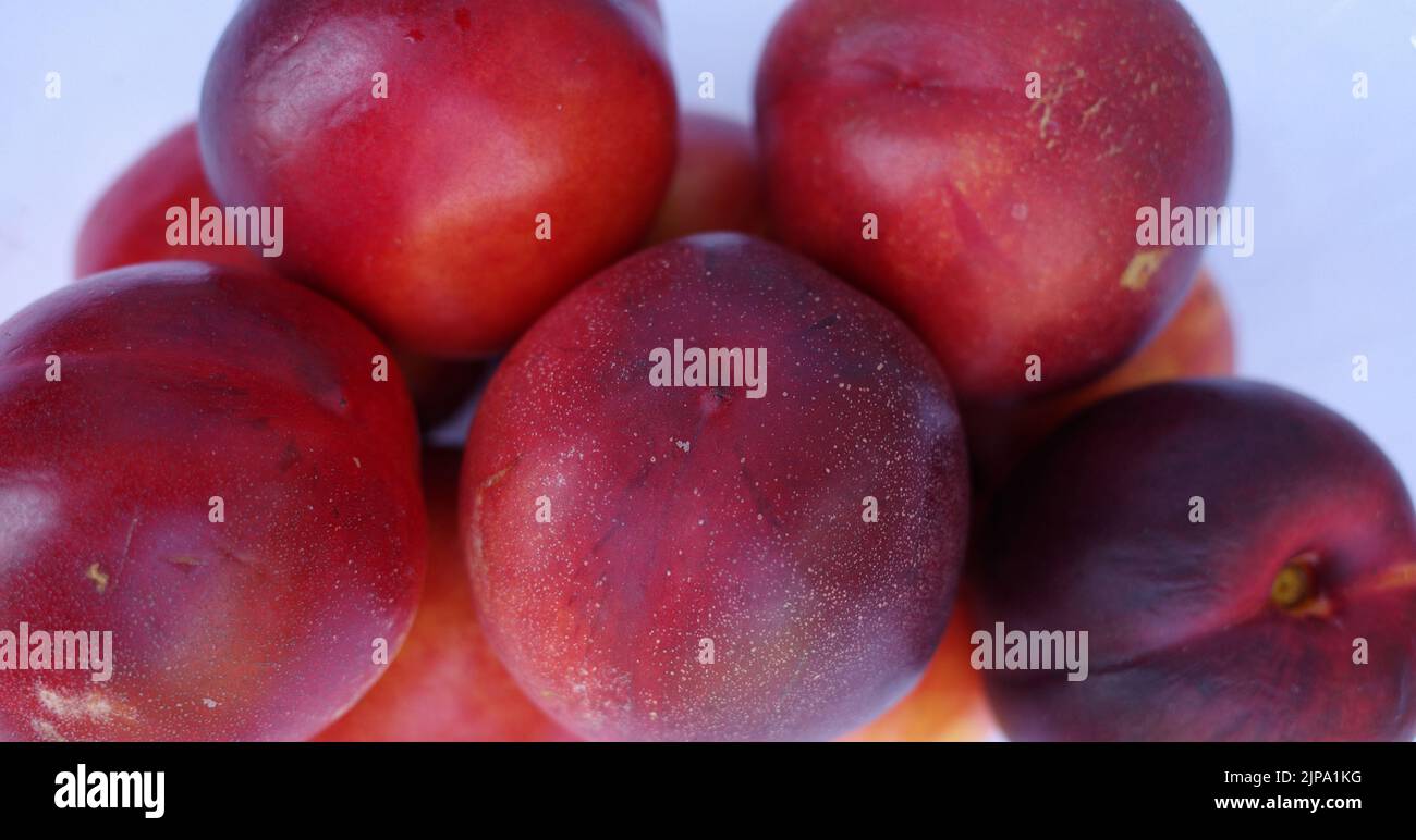 A heap of nectarines. A nectarine is a peach with a glossy and smooth ...