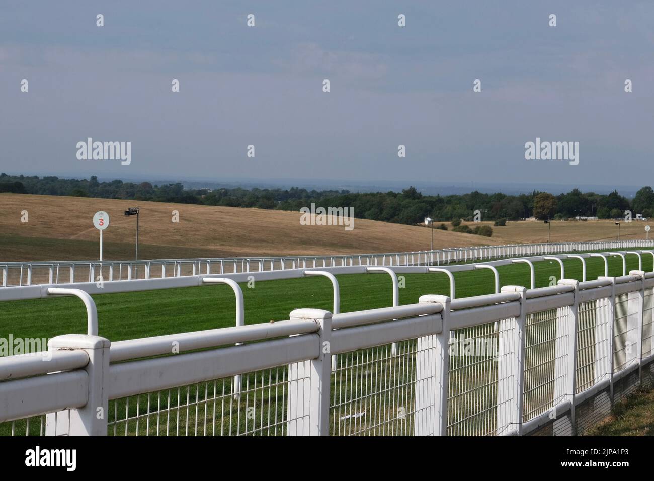 Epsom Racecourse railings at three furlong marker Stock Photo - Alamy