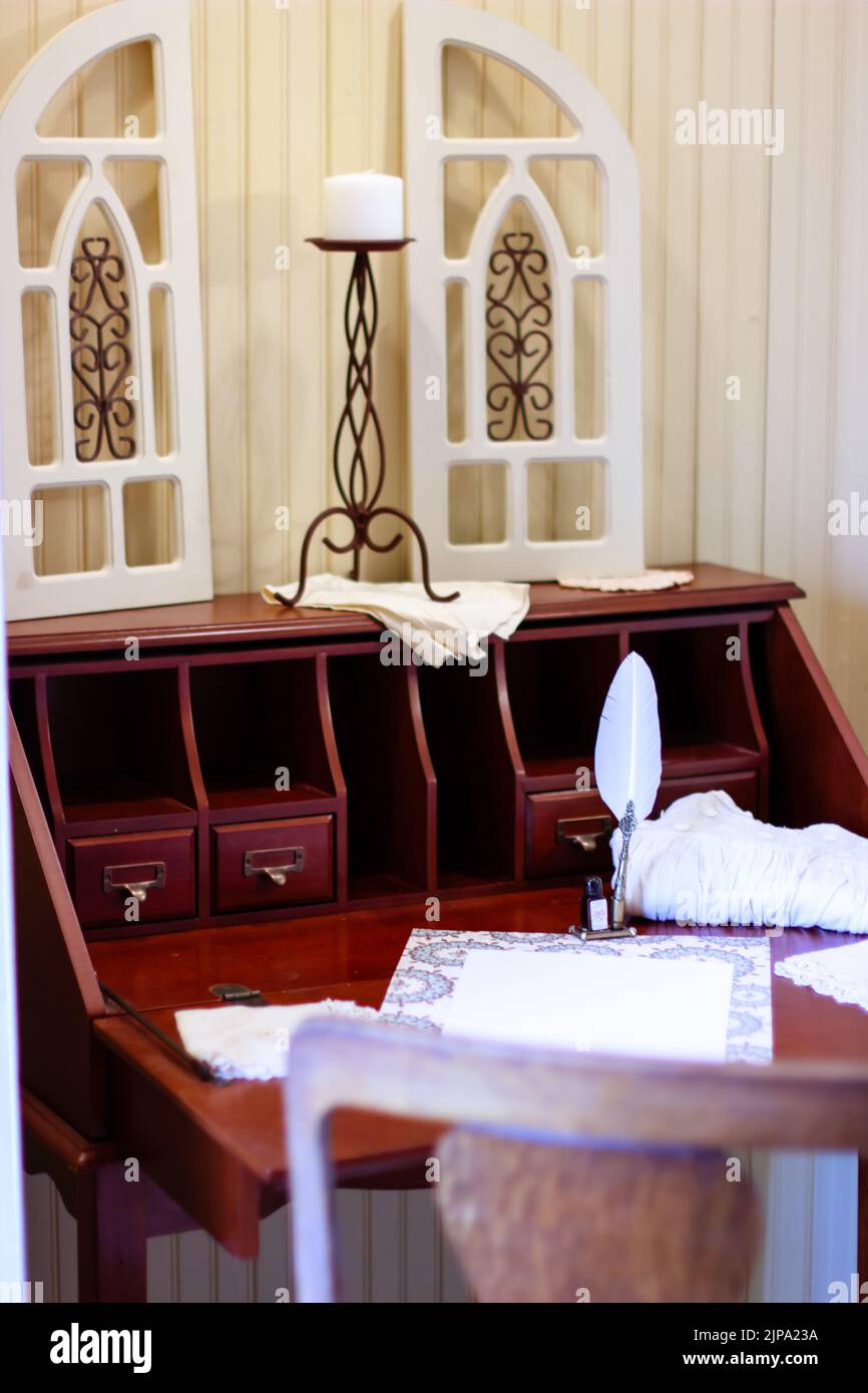 Desk with writing quill Stock Photo - Alamy