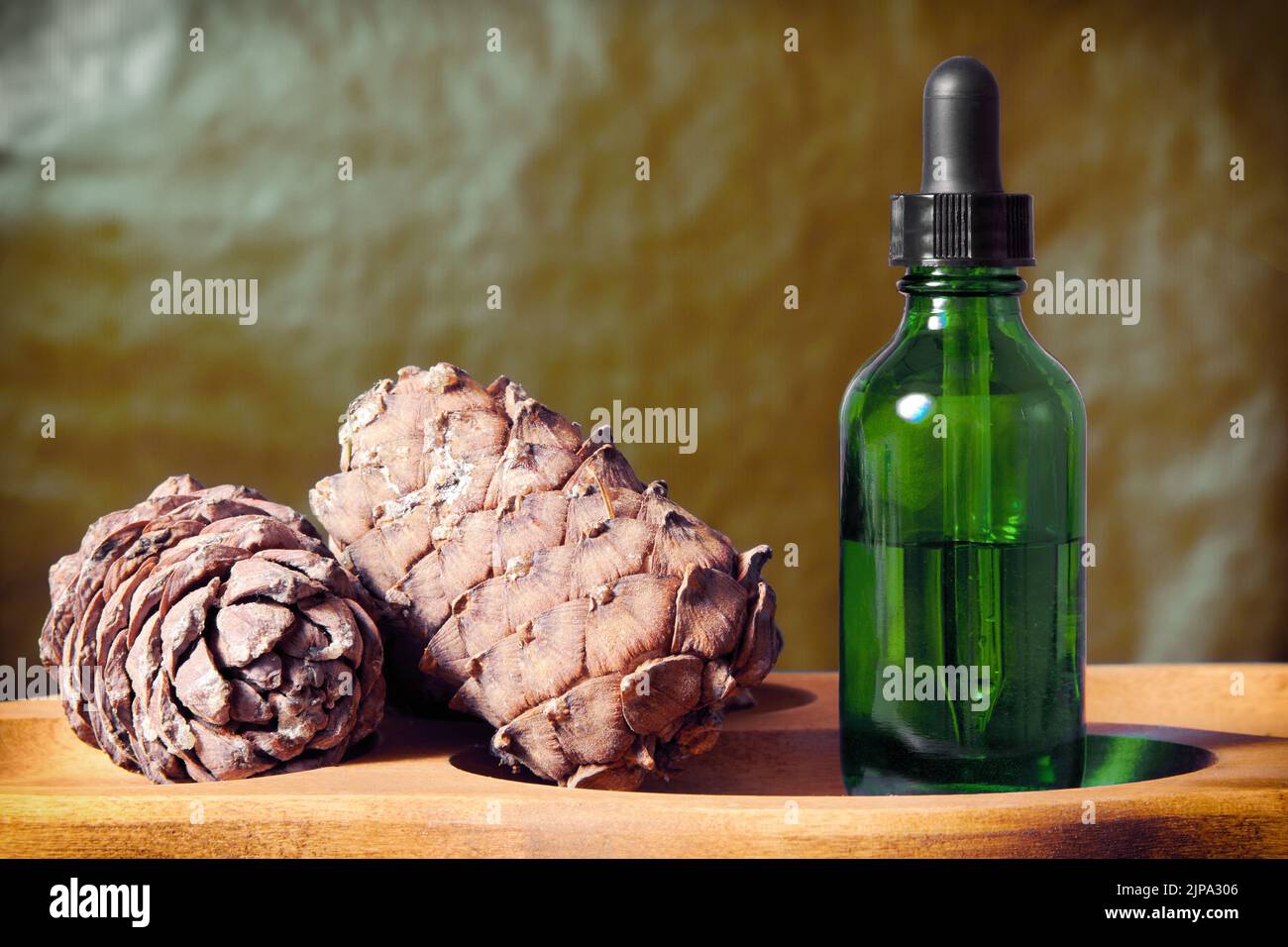 Green bottle with natural essential oil and pipette on the display ...