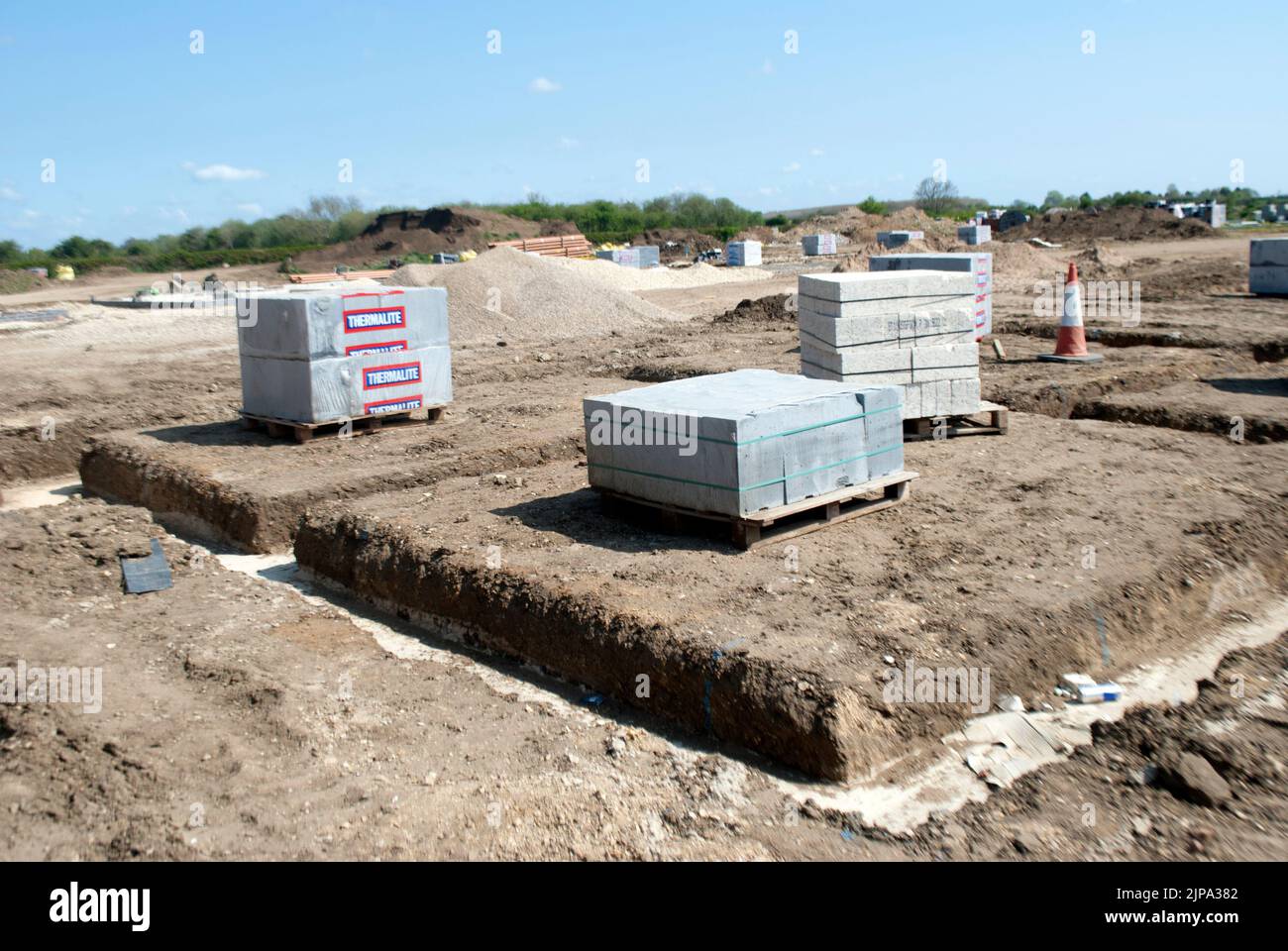 Pallets of stacked house construction materials - breeze blocks and ...
