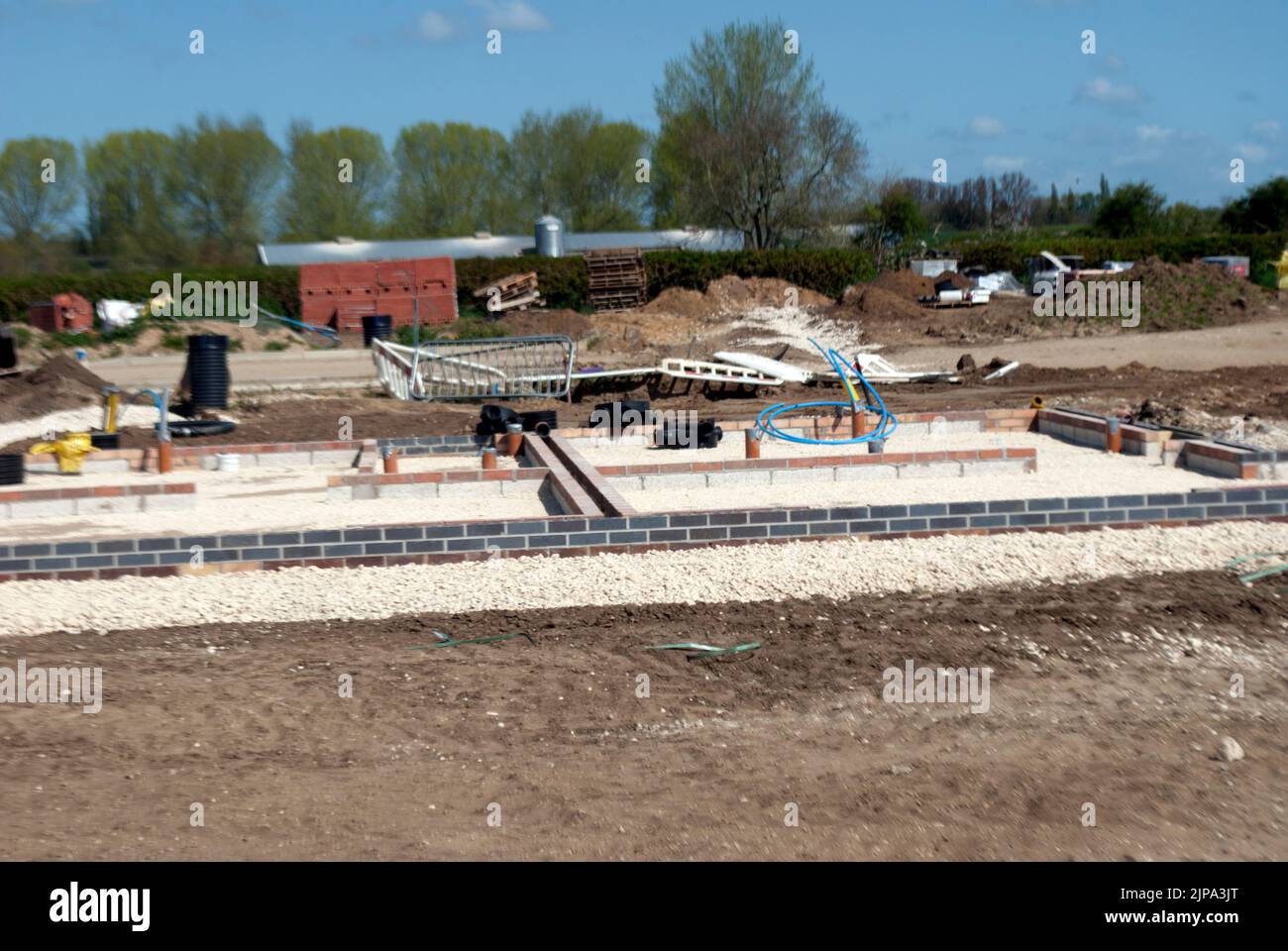 Foundations for houses on building site with trees in the back ground ...