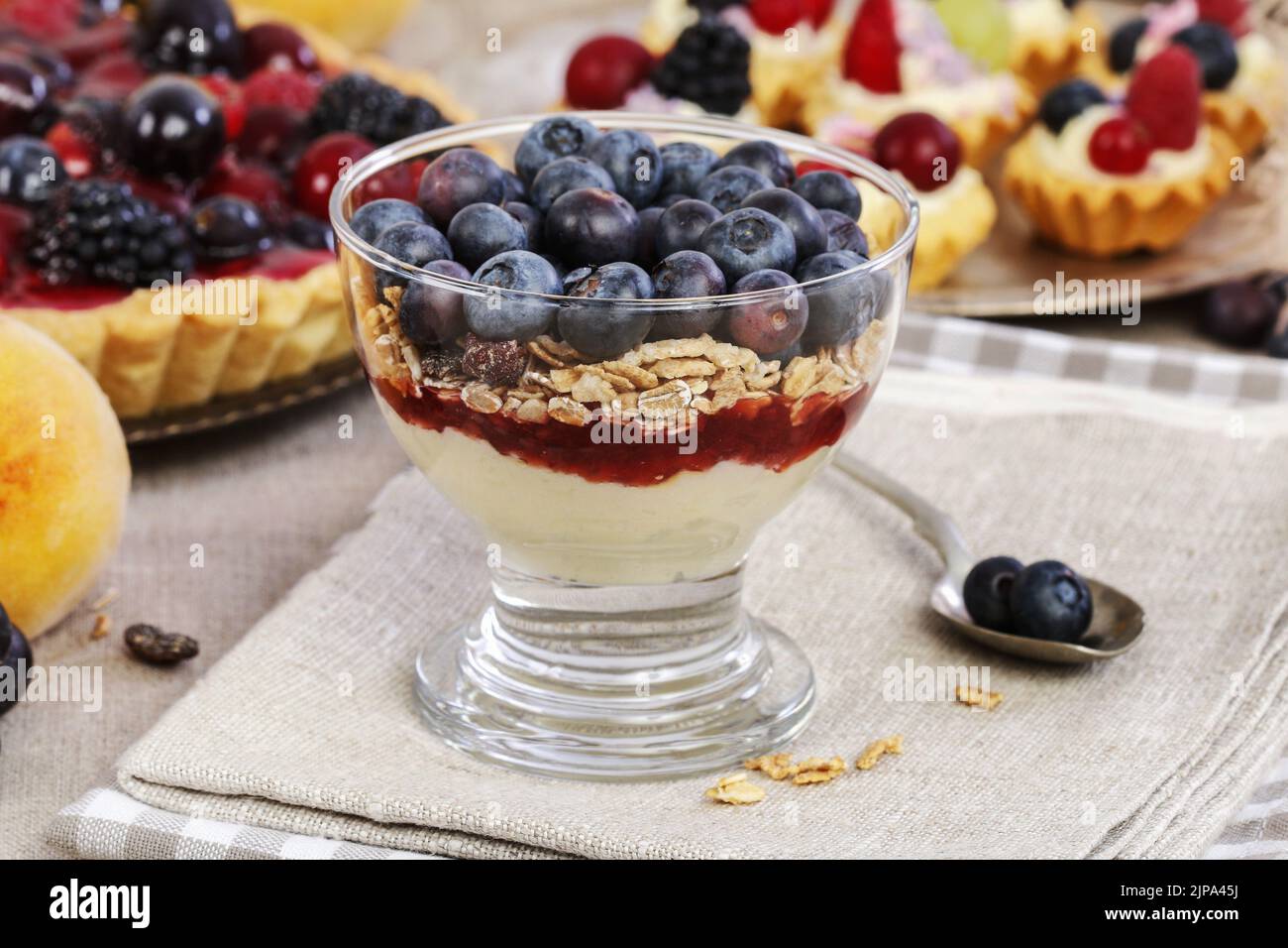 Portion of layer dessert with fresh fruits and muesli. Party dessert ...