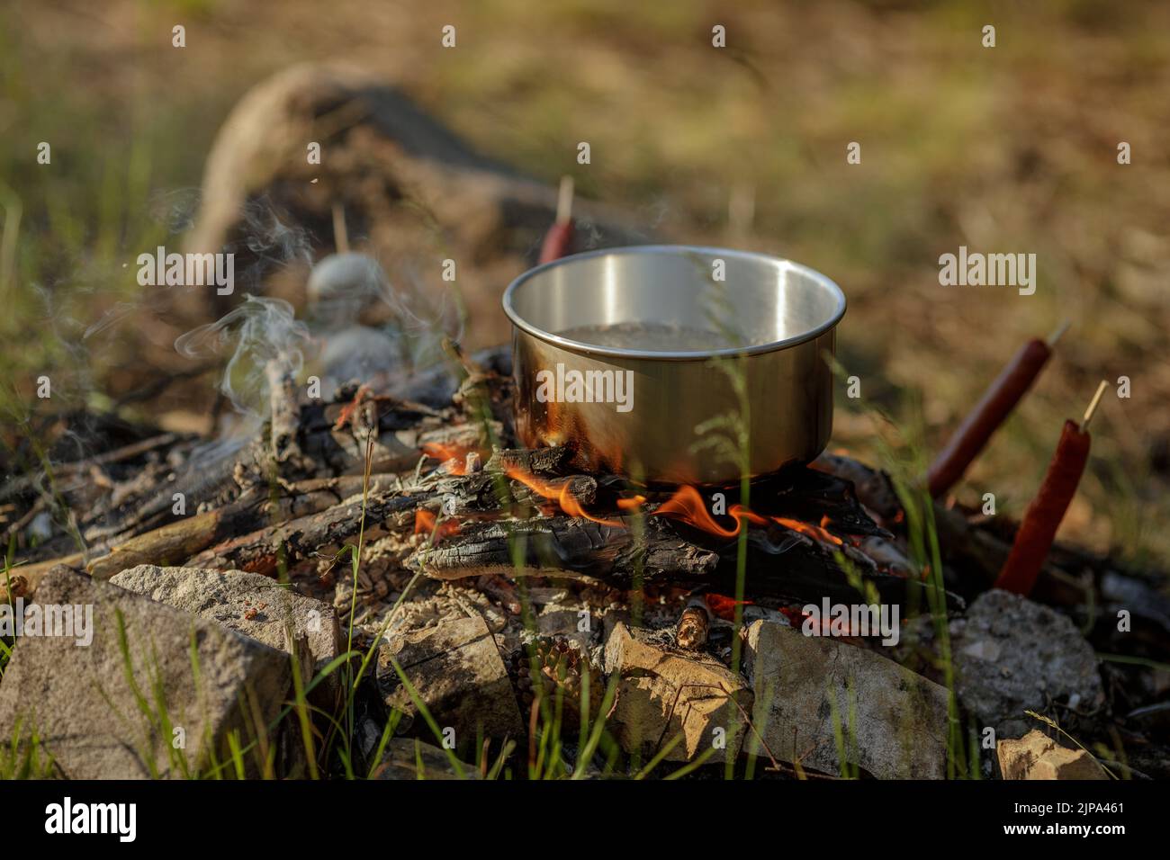Cooking food in pot on campfire. The concept of adventure, travel ...