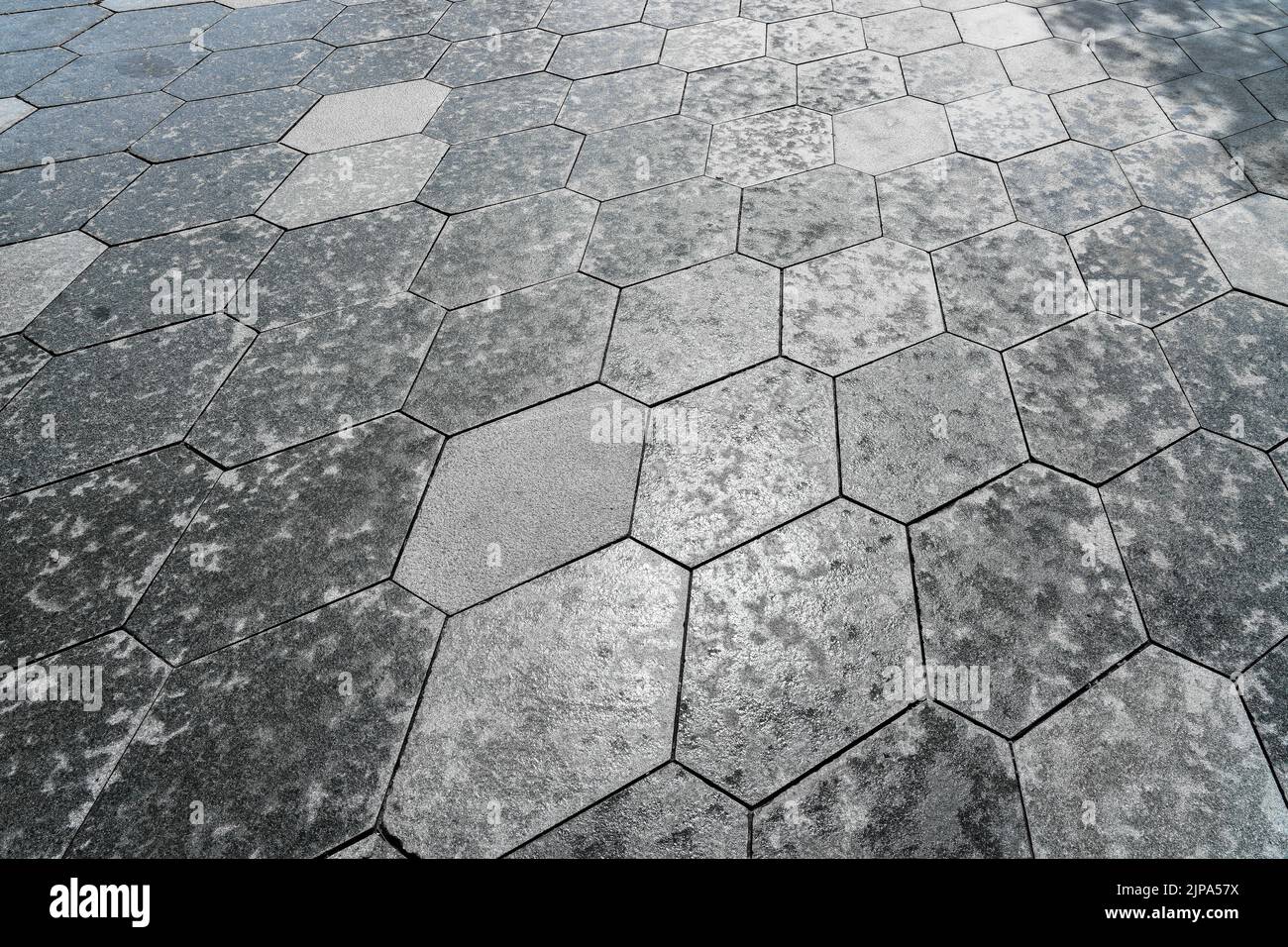 The texture of a monotonous hexagonal tiled pavement with perspective ...