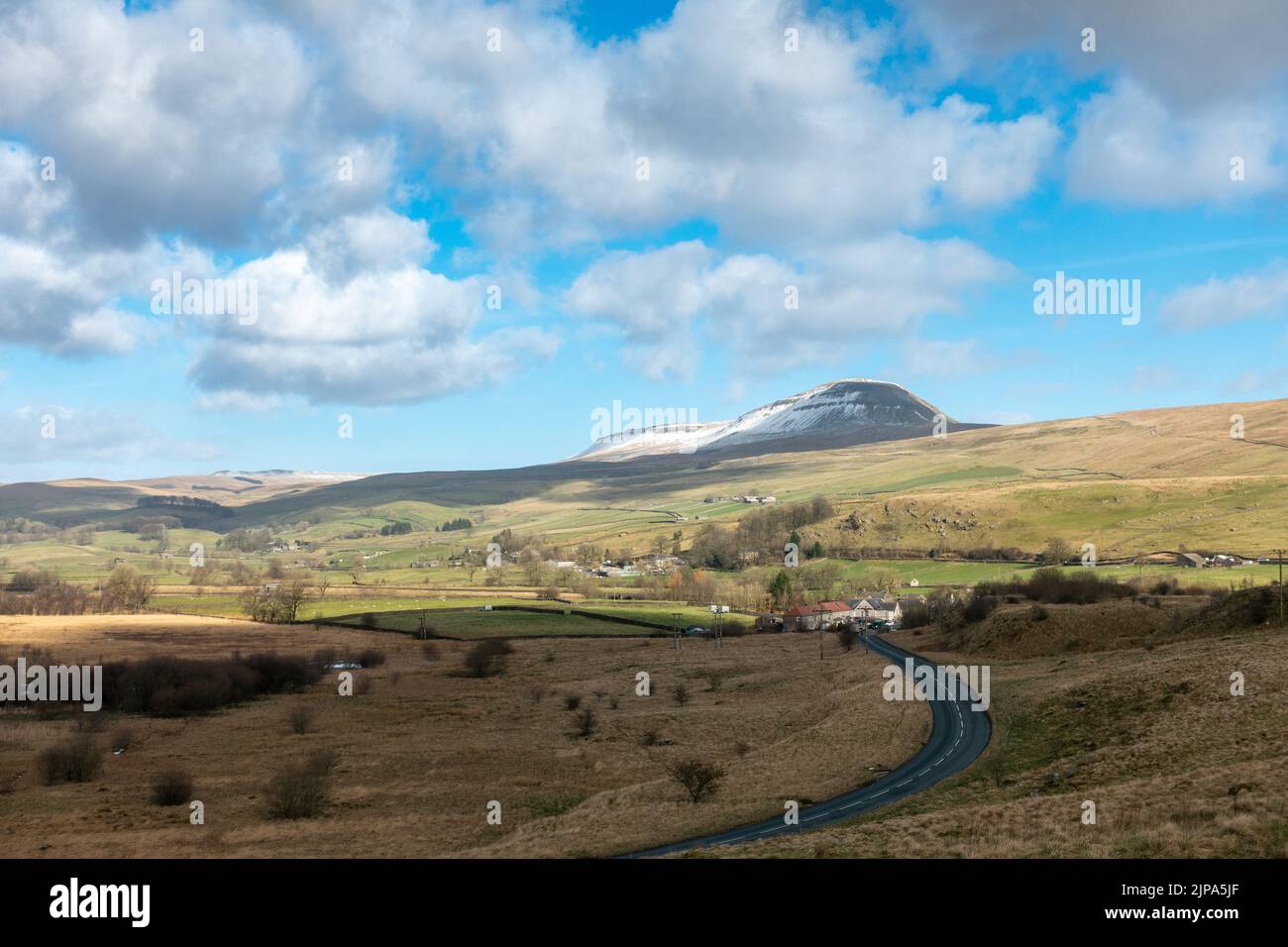 Stunning view of a snow-capped Pen-y-ghent mountain in the Yorshire ...