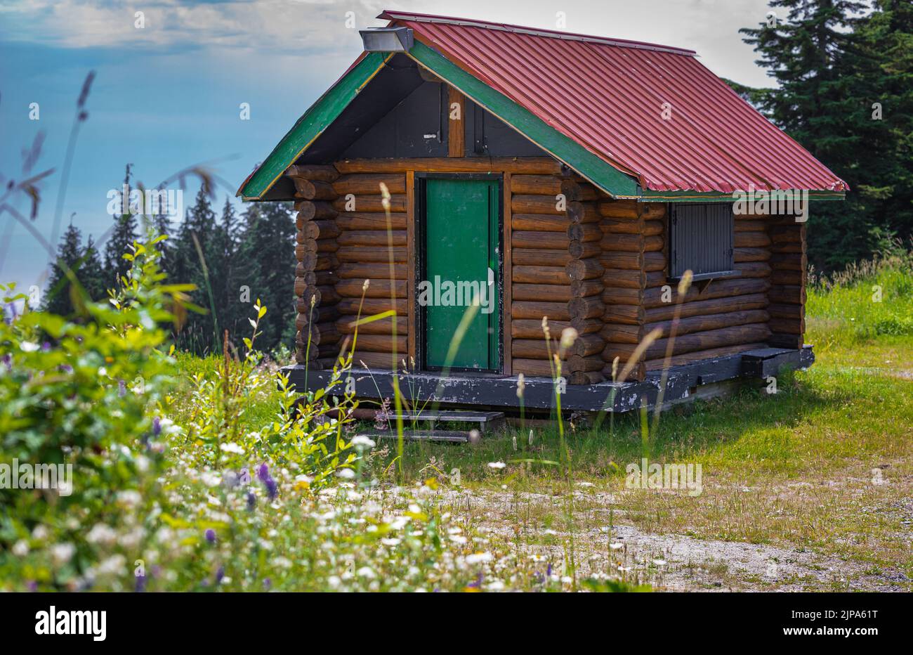 Old wooden hut cabin in mountain alps at rural summer landscape. Cozy ...