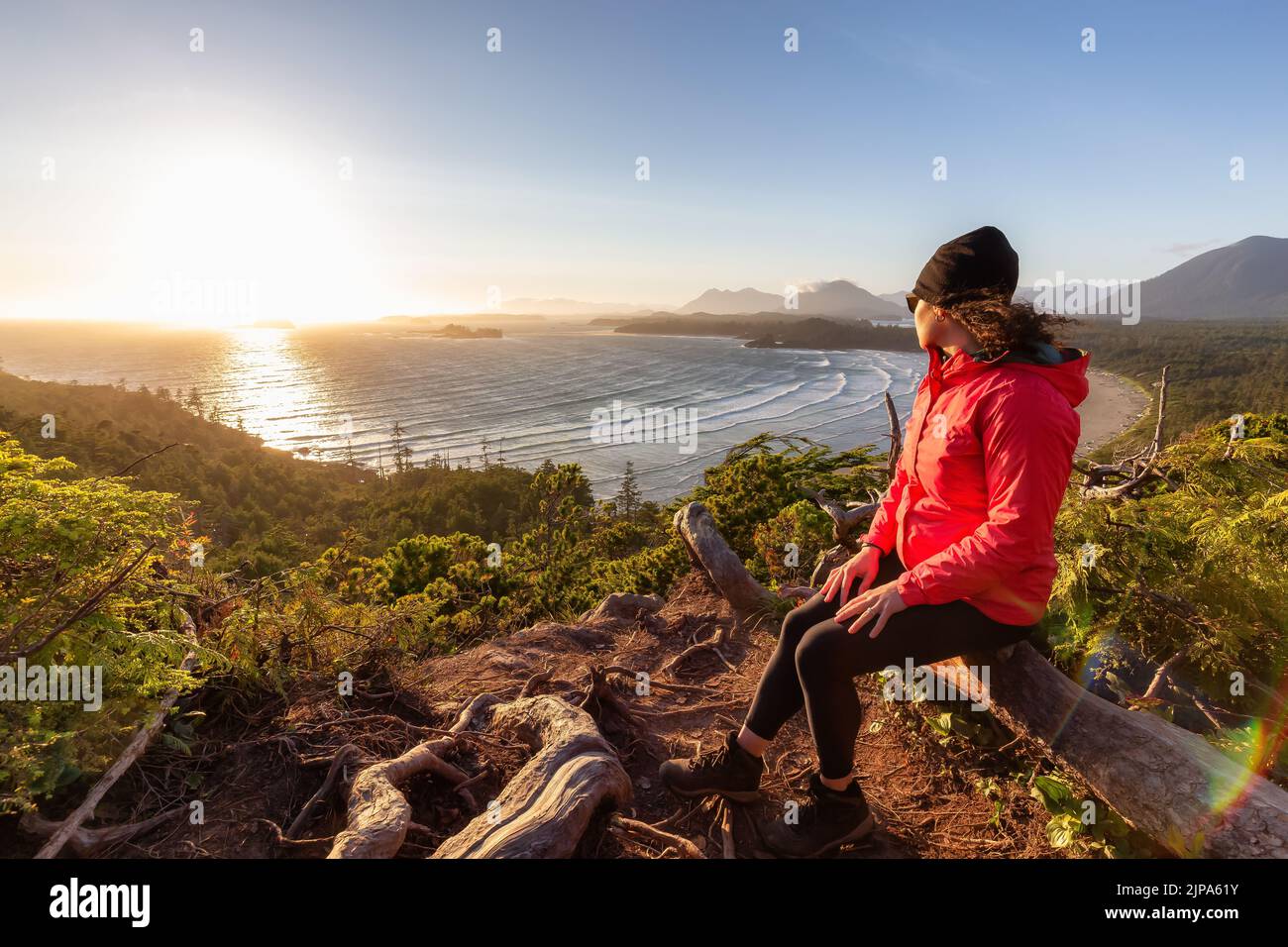 Adventurous Woman Hiker overlooking Sandy Beach on the West Coast of ...
