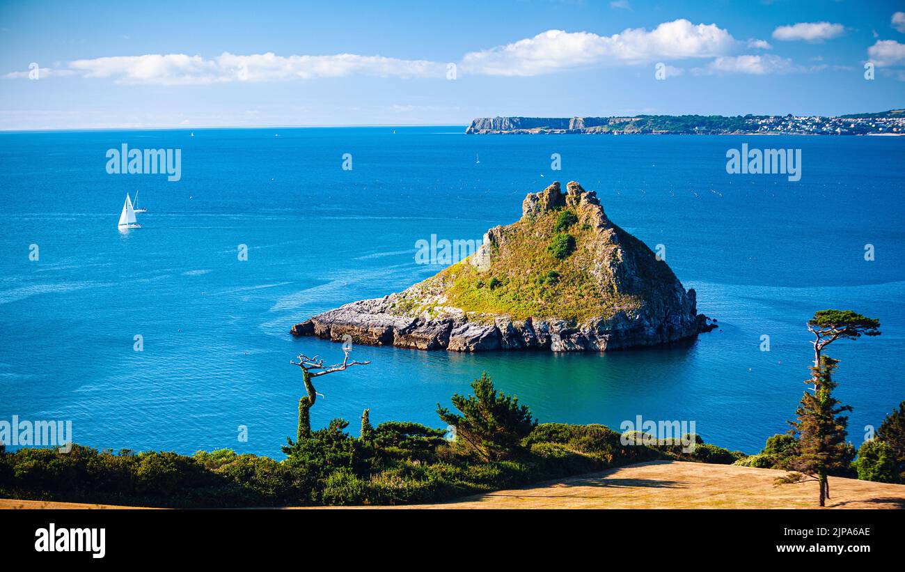 An aerial view of a small island formation surrounded by the blue ocean ...