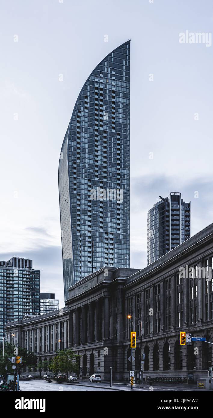 A vertical shot of Toronto union station next to skyscrapers with a ...