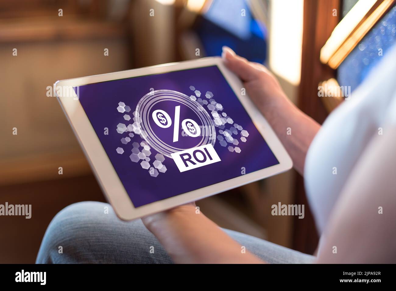 Woman holding a tablet showing roi concept Stock Photo - Alamy