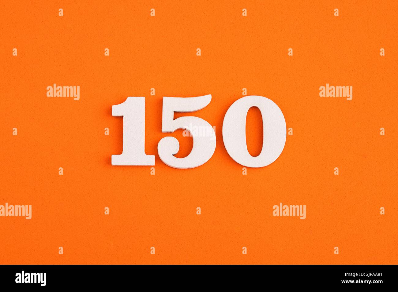 White wooden number 150 on eva rubber orange background Stock Photo - Alamy