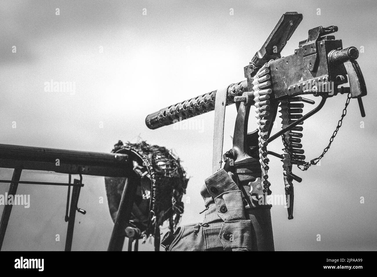 A grayscale of a heavy machine gun at the 'FlyWheel' festival at ...
