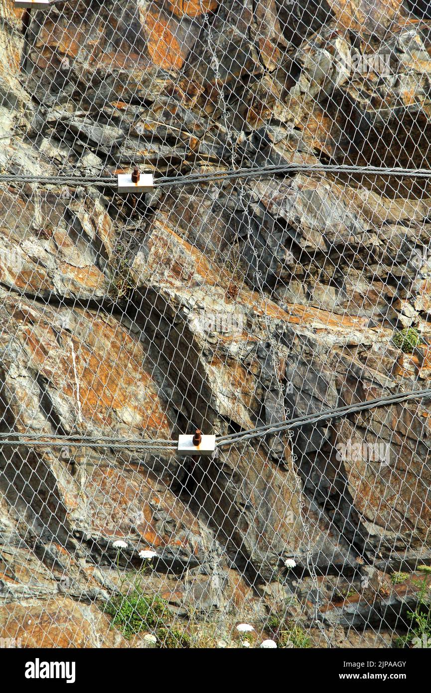 detail of a mesh rockfall barrier draped along Stock Photo - Alamy